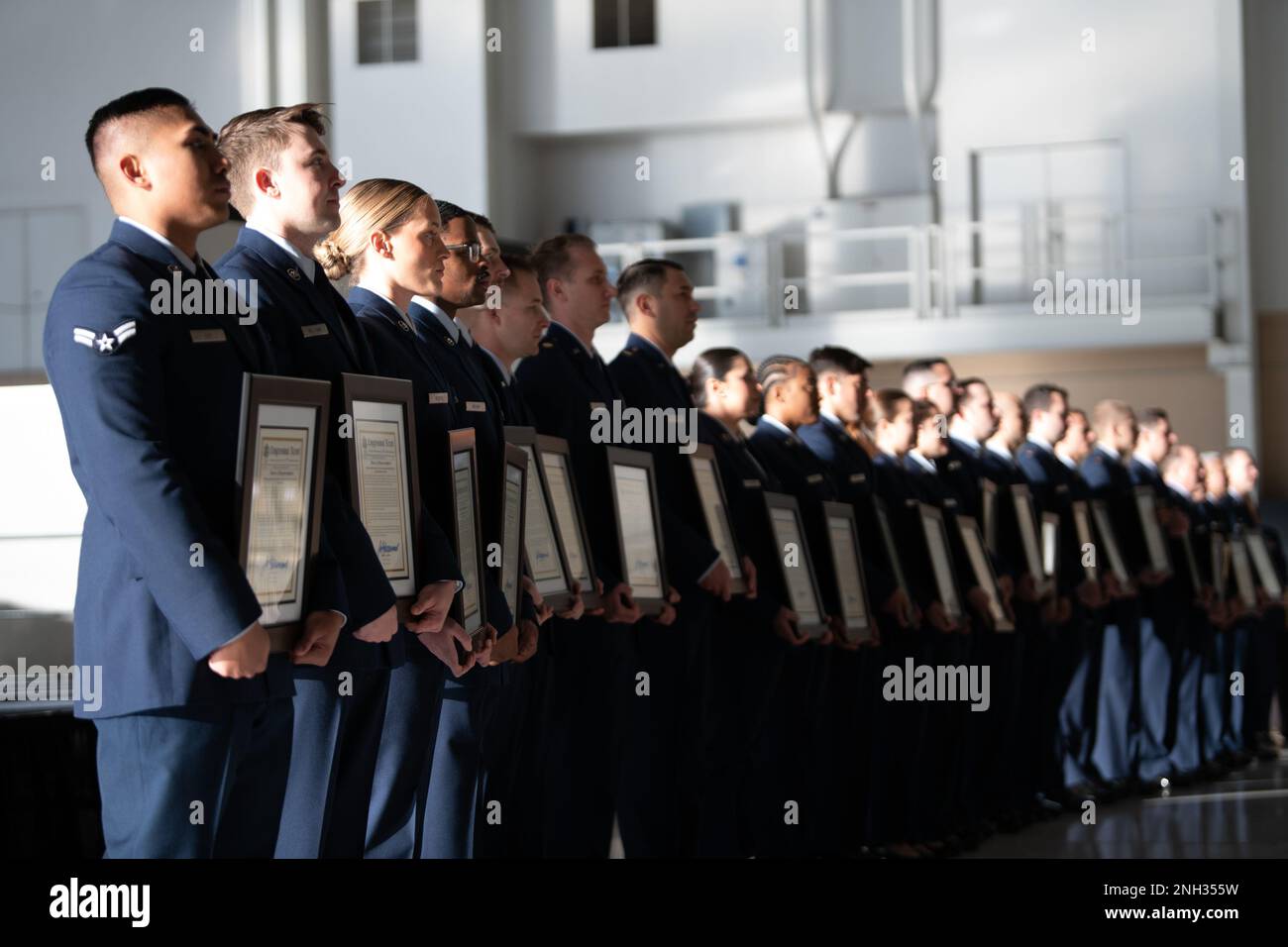 U.S. Airmen and recipients of the Distinguished Flying Cross hold copies of their congressional ...