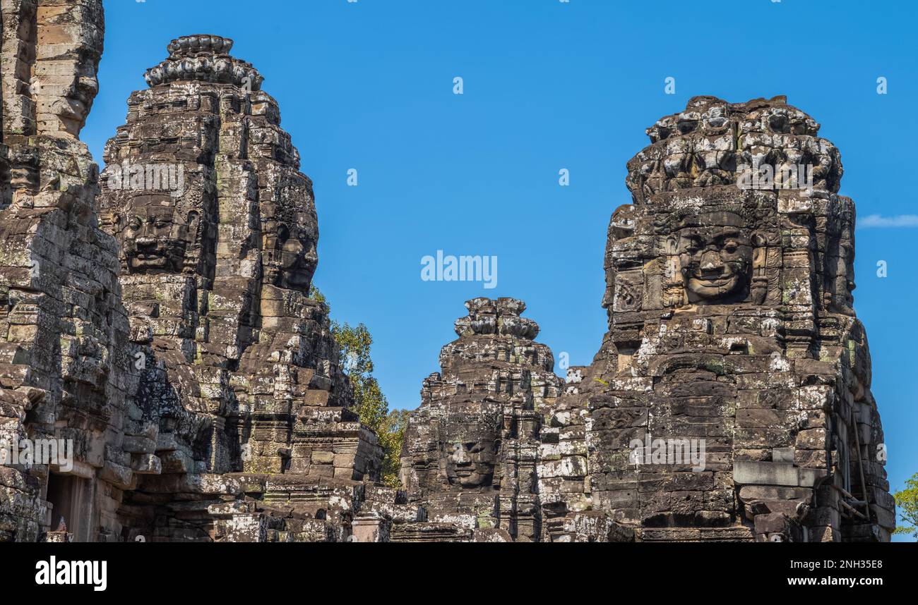 Giant carved faces carved into rock on the ancient Bayon Temple within ...