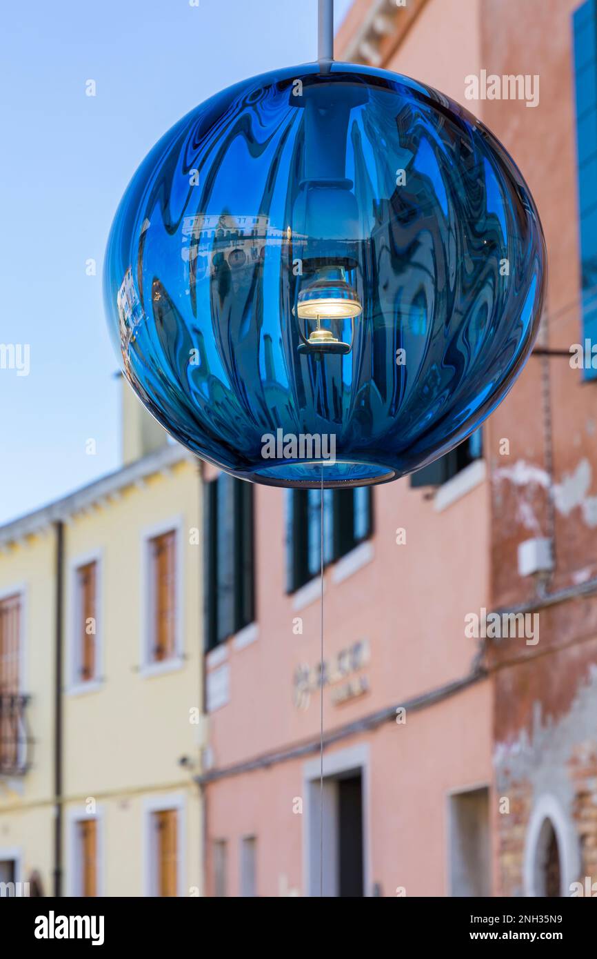 Close up of blue Murano glass light with reflections hanging at Murano, Venice, Italy in ...