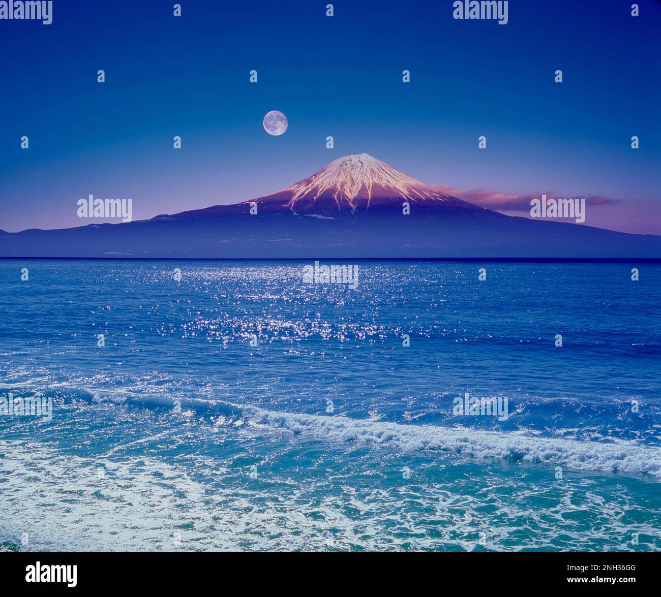 Mt. Fuji, Japan across the water with moon in the frame Stock Photo - Alamy