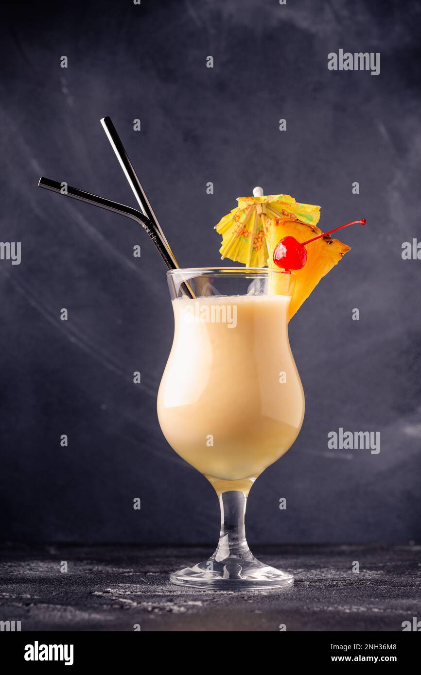 Traditional caribbean cocktail pina colada in a glass, garnished with a ...