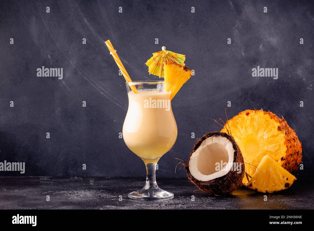 Traditional caribbean cocktail pina colada in a glass, garnished with a ...