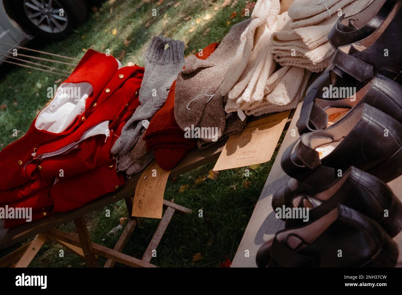 Vintage colonial tunics, wool socks, and shoes are on display for sale ...