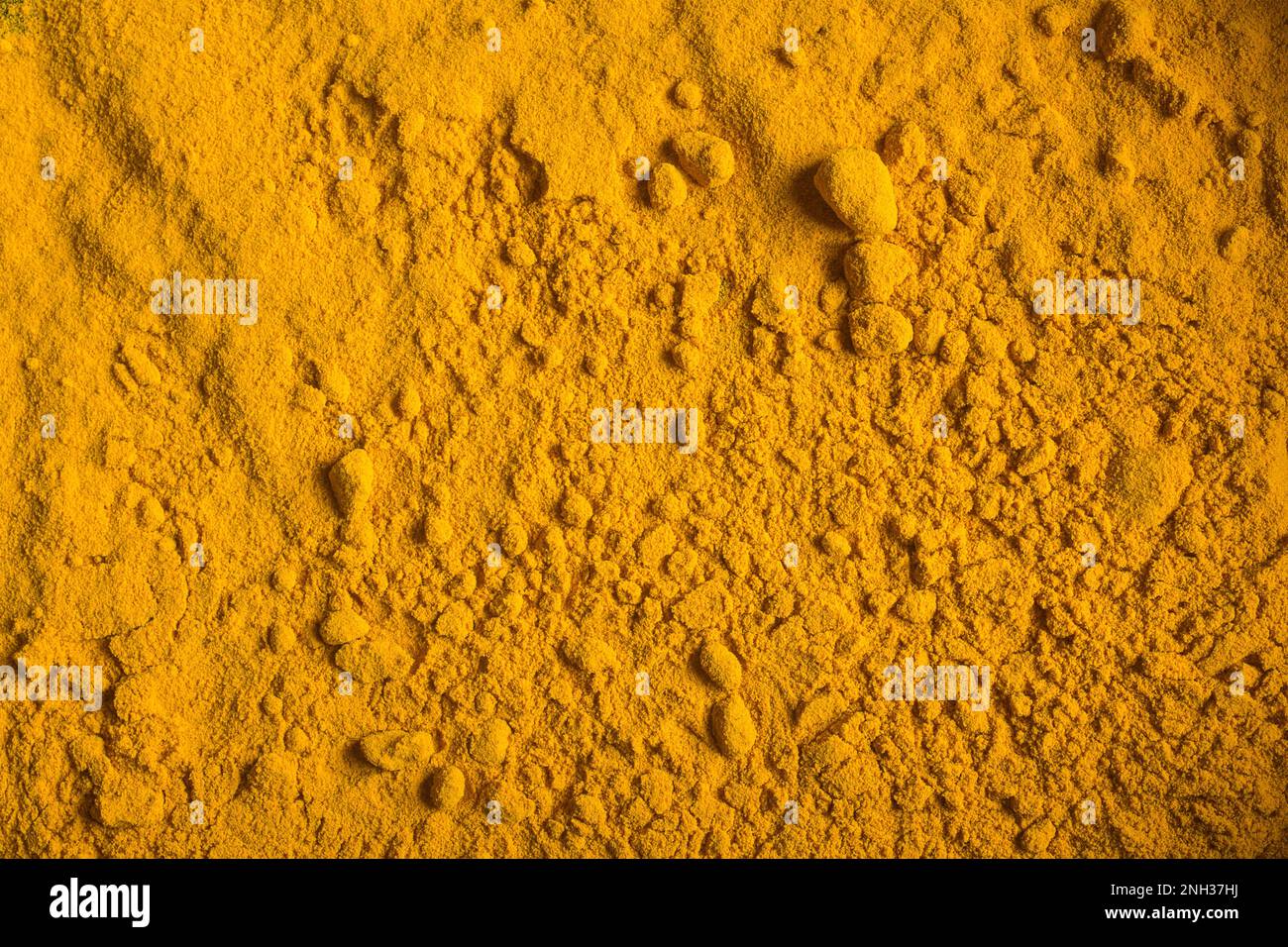 Turmeric powder spread on a flat surface for an uneven landscape with ...