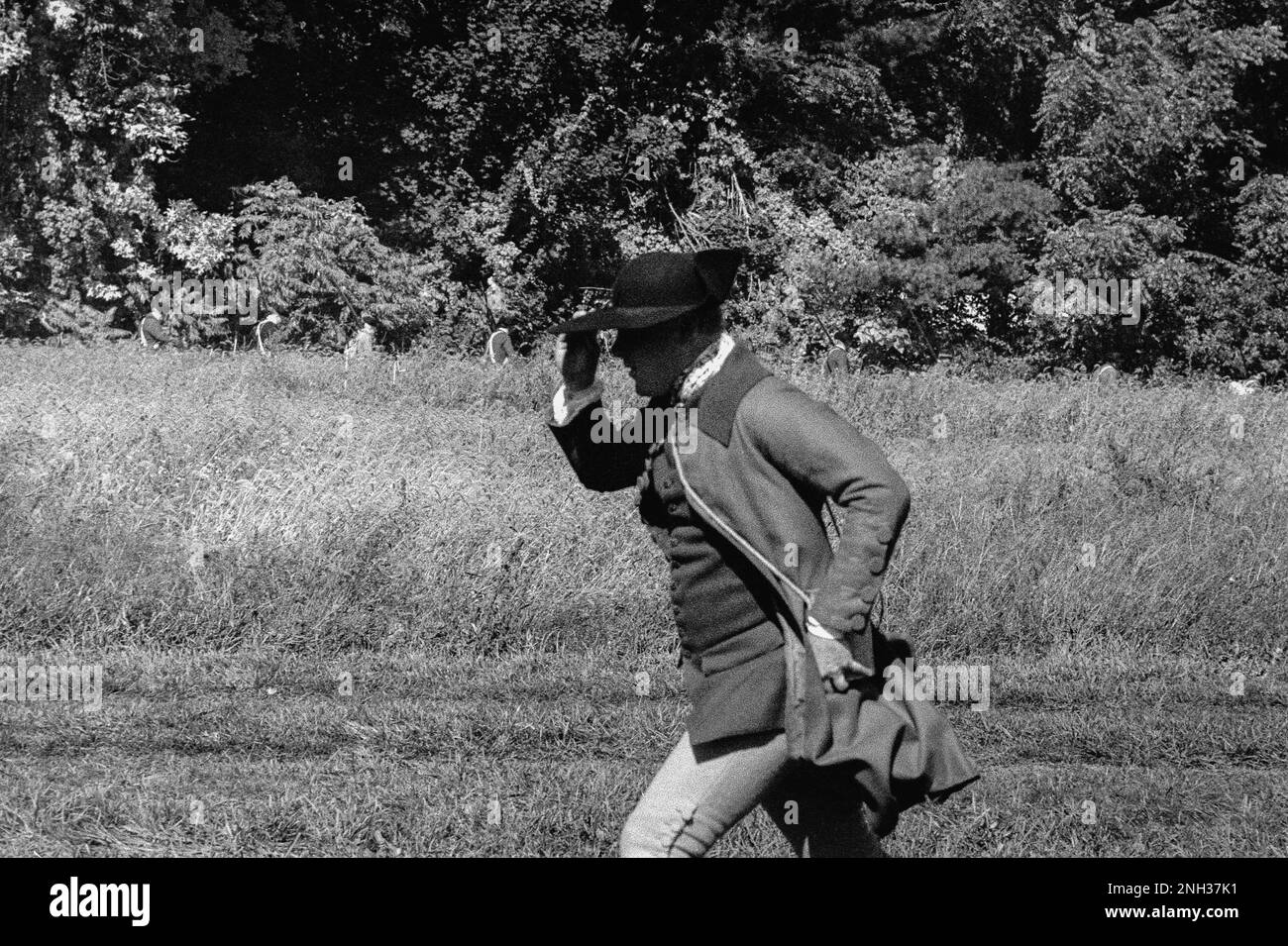 A colonial soldier runs from the line of fire on the battlefield during ...