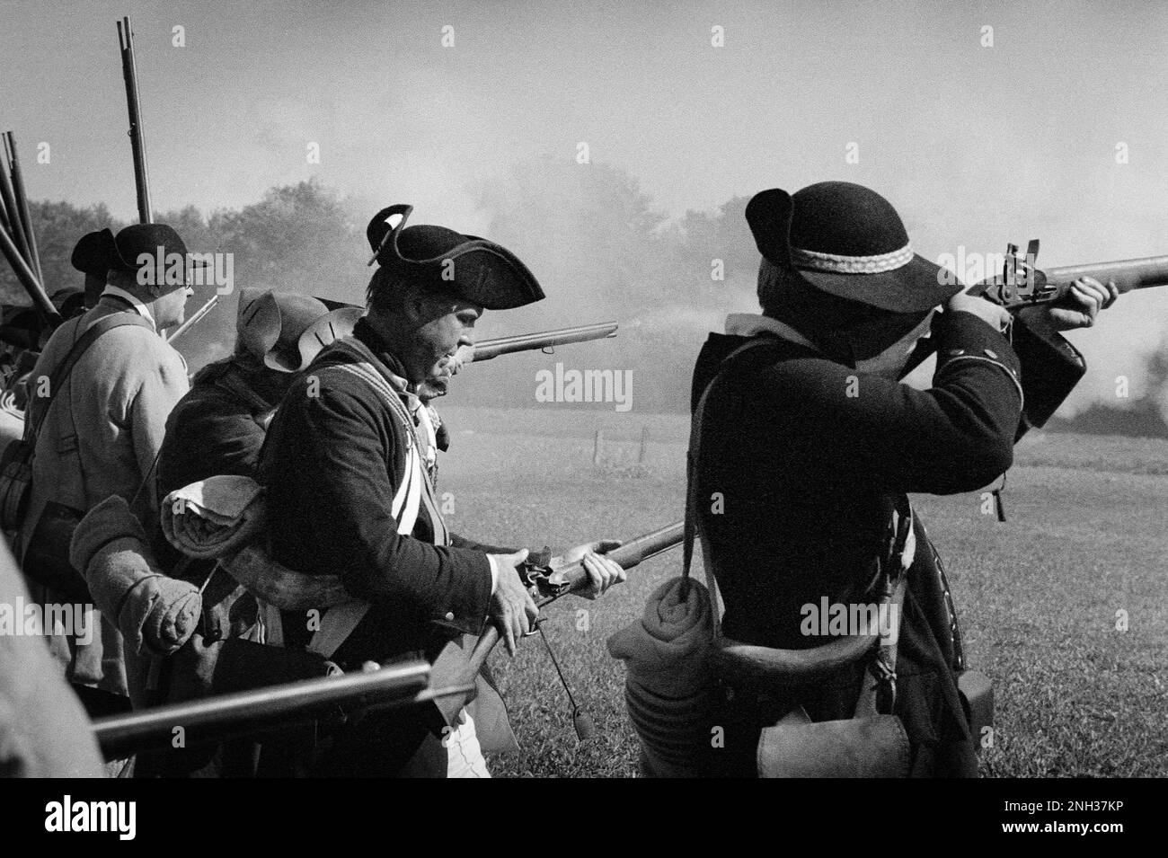 Colonial soldiers in a cloud of smoke fire their muskets at Red Coats ...