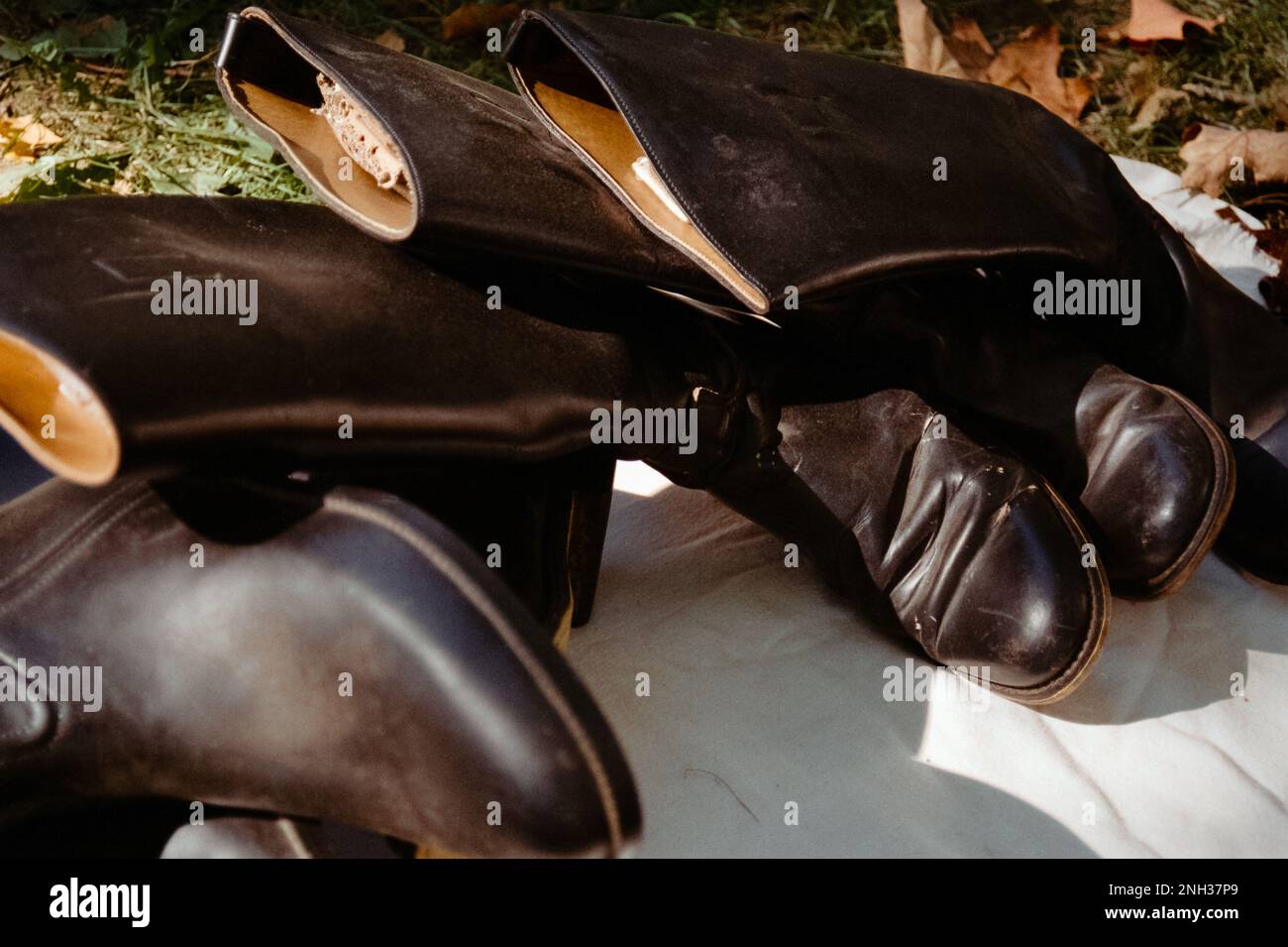 Vintage colonial soldiers boots stack on a table for sale during the ...