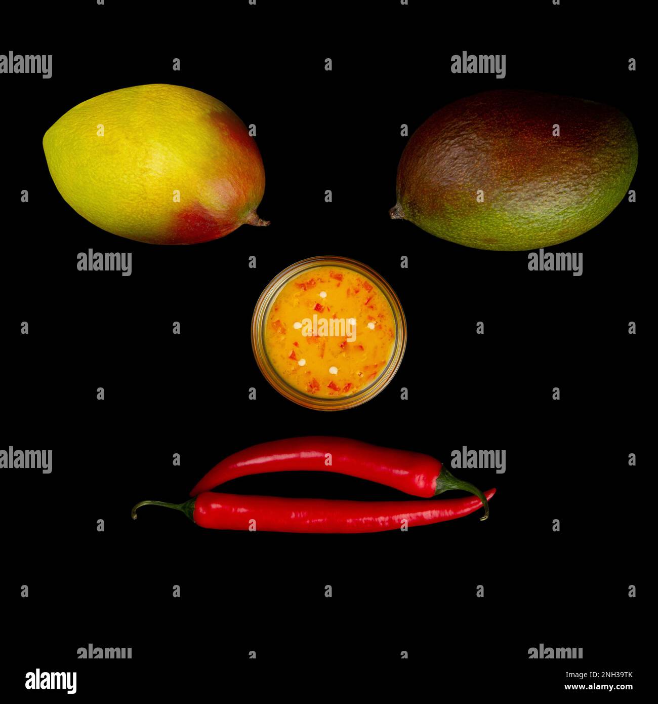 Jokey face made of mango, chili and mango chili sauce on black ...
