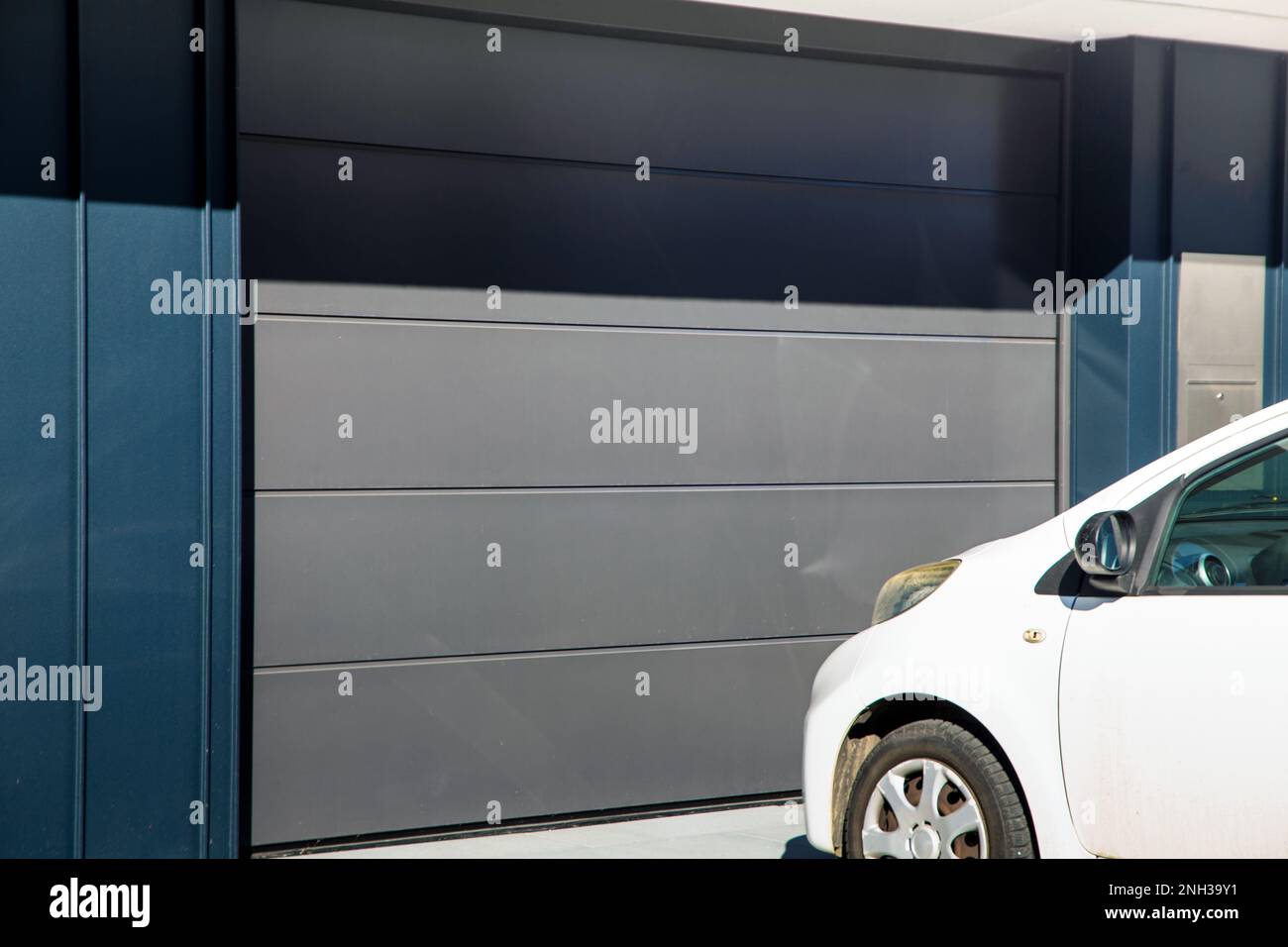 Modern garage door (sectional door) with car parked in front Stock ...