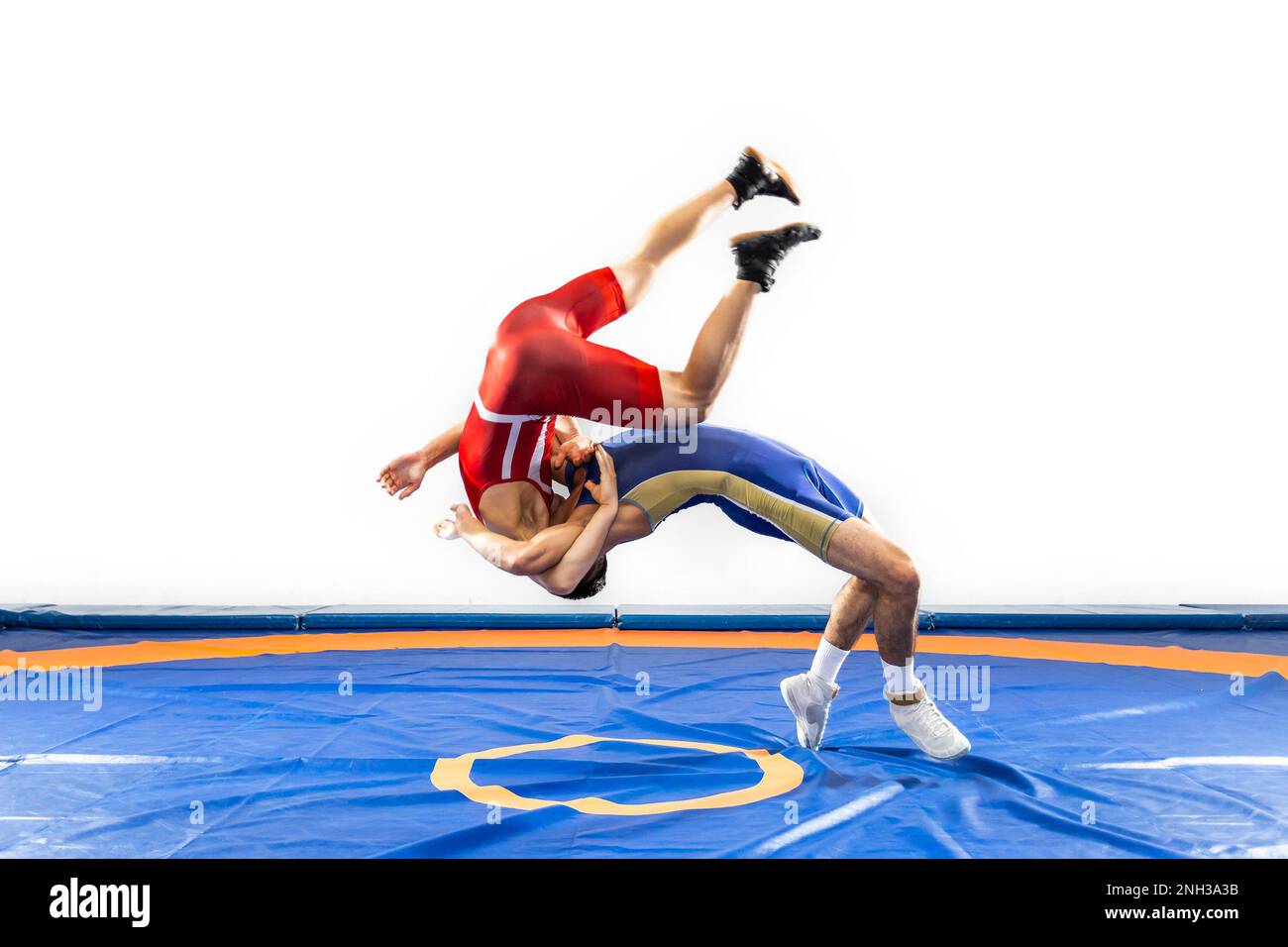 Two strong men in blue and red wrestling tights are wrestlng and making ...