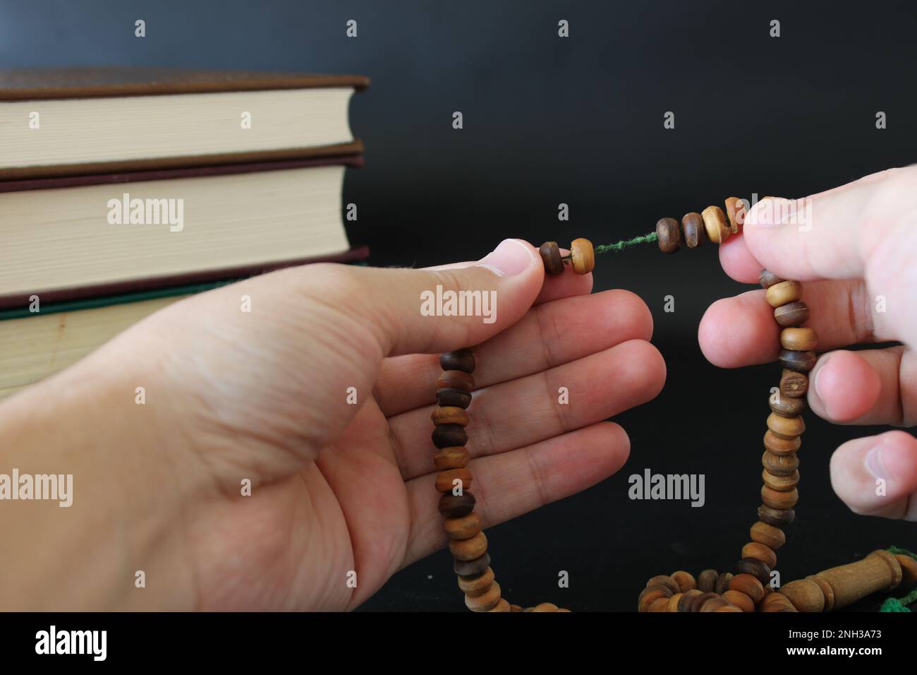 hand of muslim praying with rosary on quran background.islamic consept ...