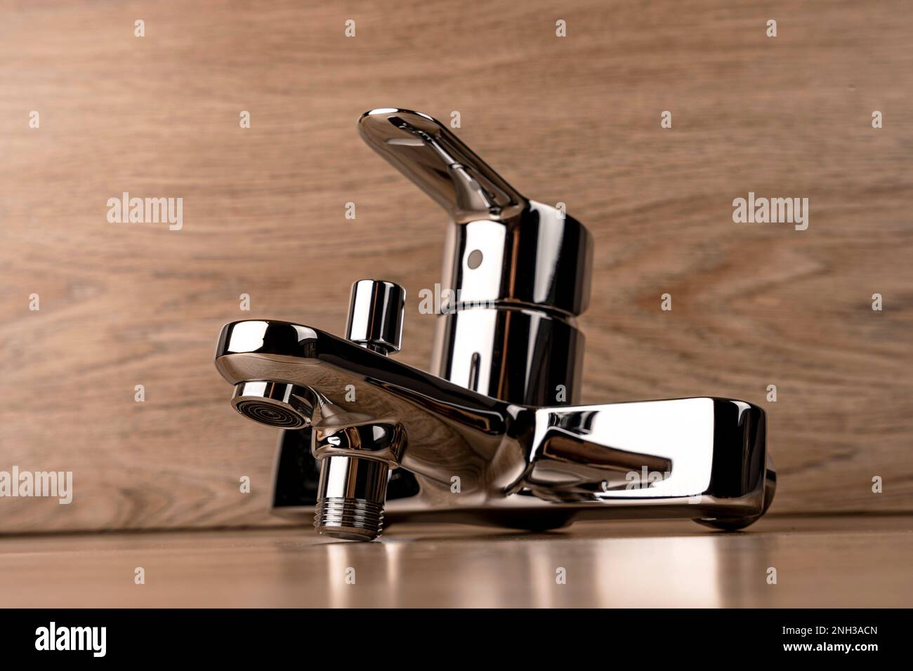 new shiny sink faucet on a ceramic tile background Stock Photo - Alamy