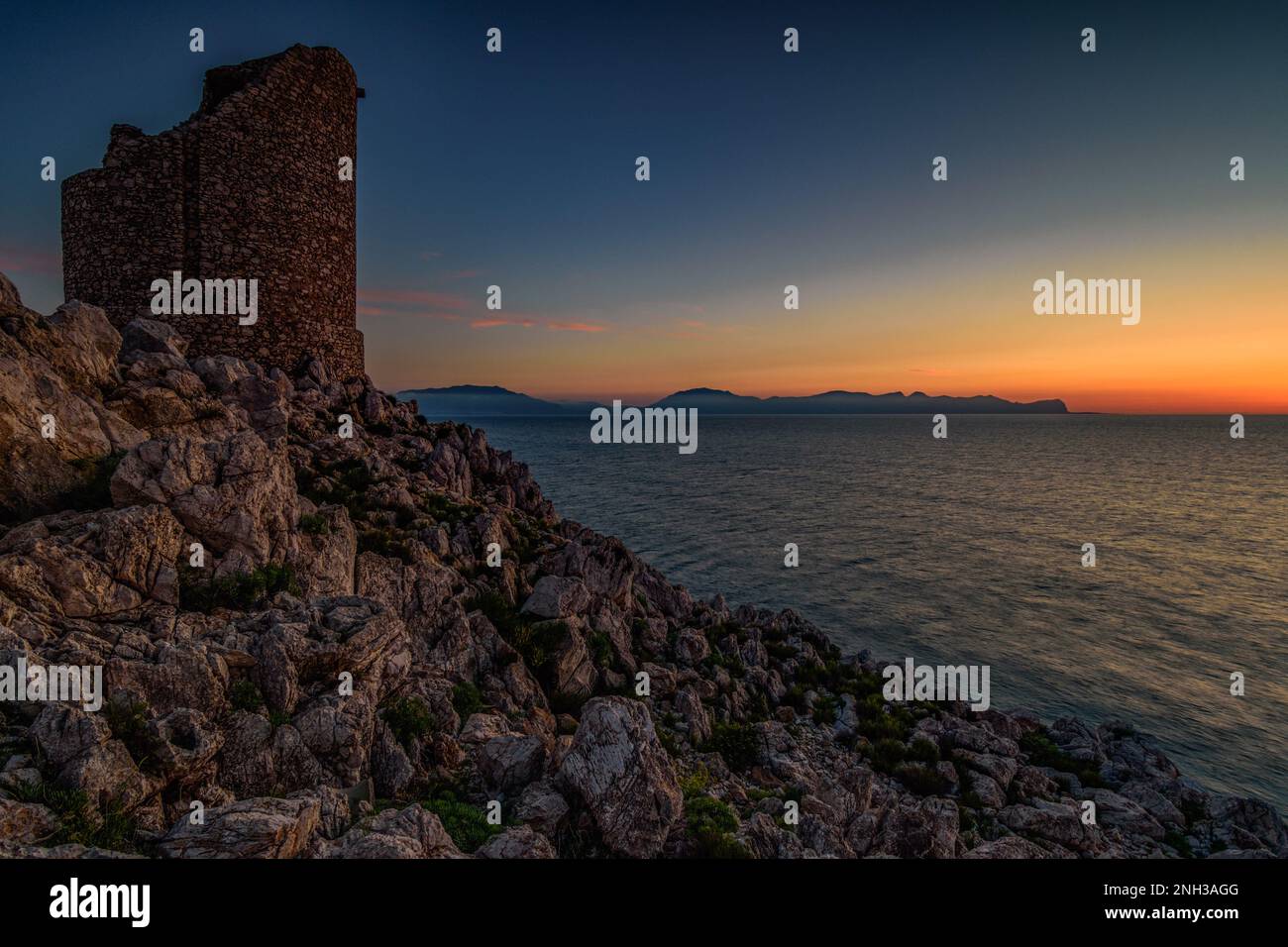 The ancient coastal tower of Capo Rama at dusk, Sicily Stock Photo - Alamy