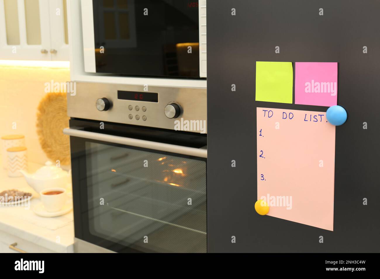 Blank To do list and sticky notes on fridge in kitchen. Space for text ...
