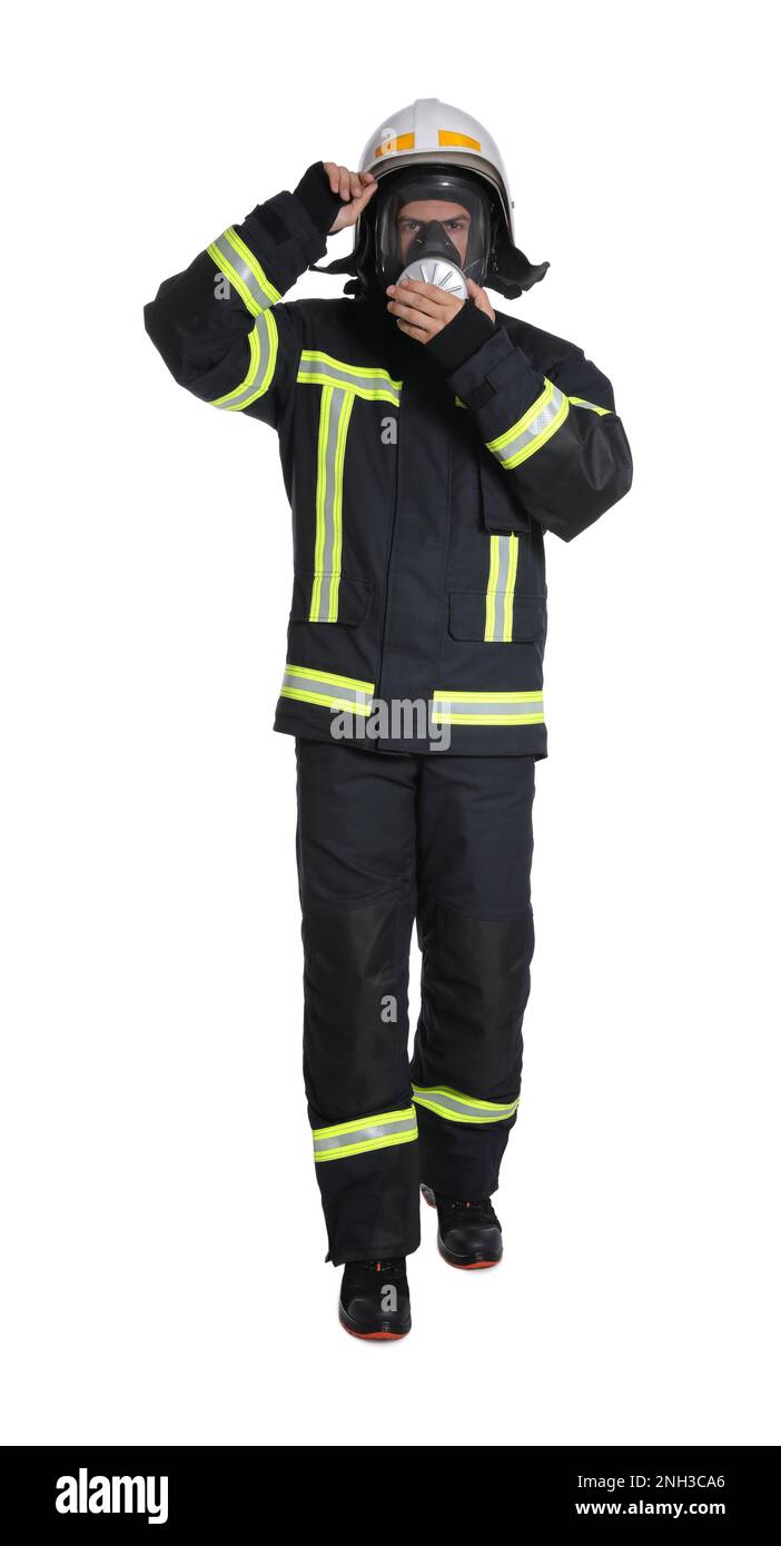 Full length portrait of firefighter in uniform, helmet and gas mask on ...