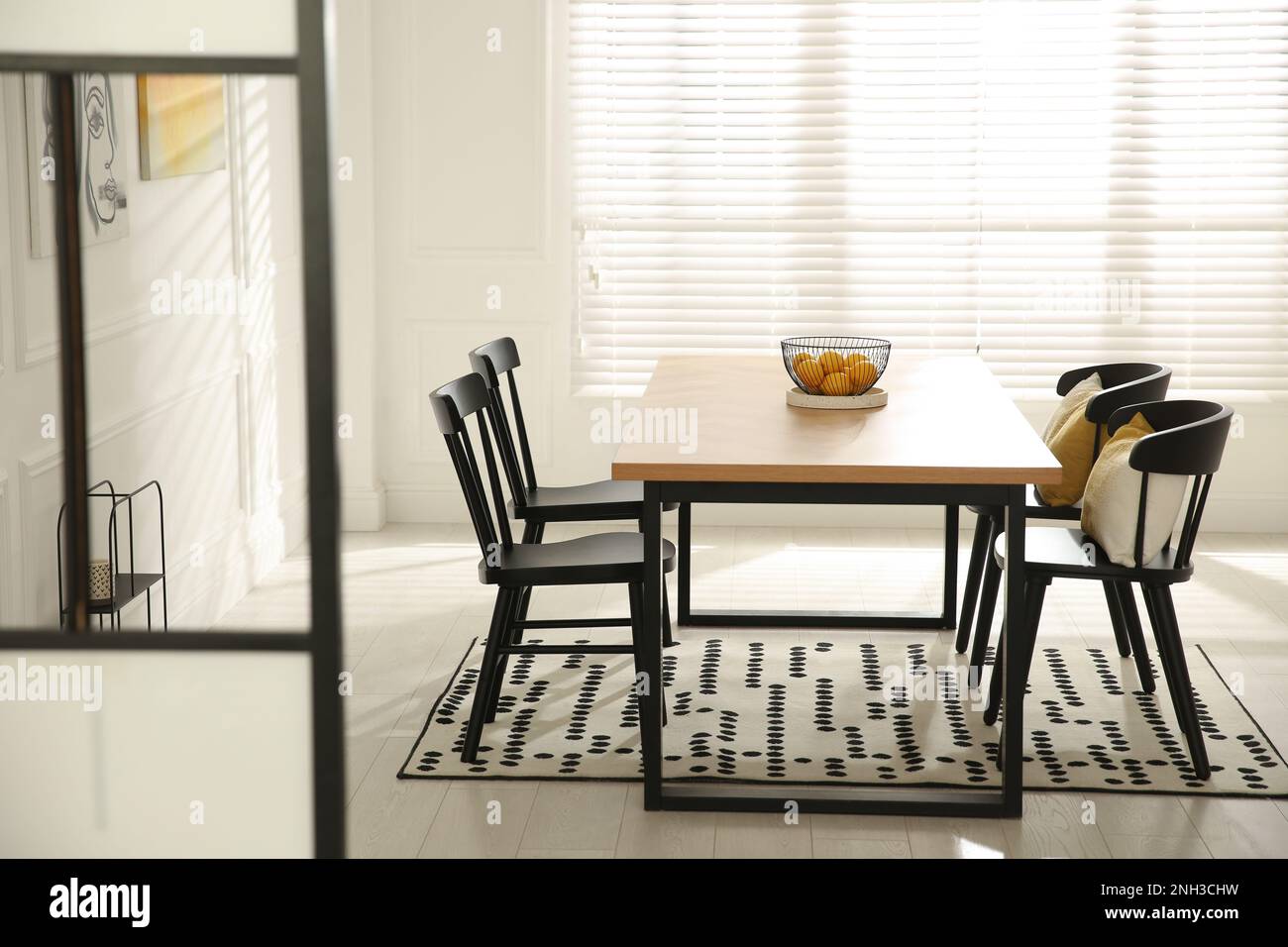 Stylish wooden dining table and chairs in room. Interior design Stock ...