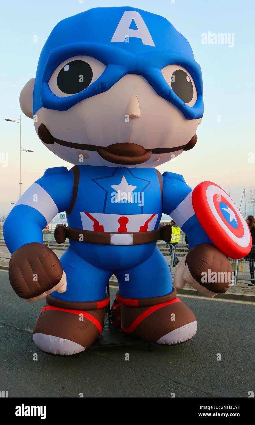 Evening carnival parade with an inflated Captain America in the Spanish ...