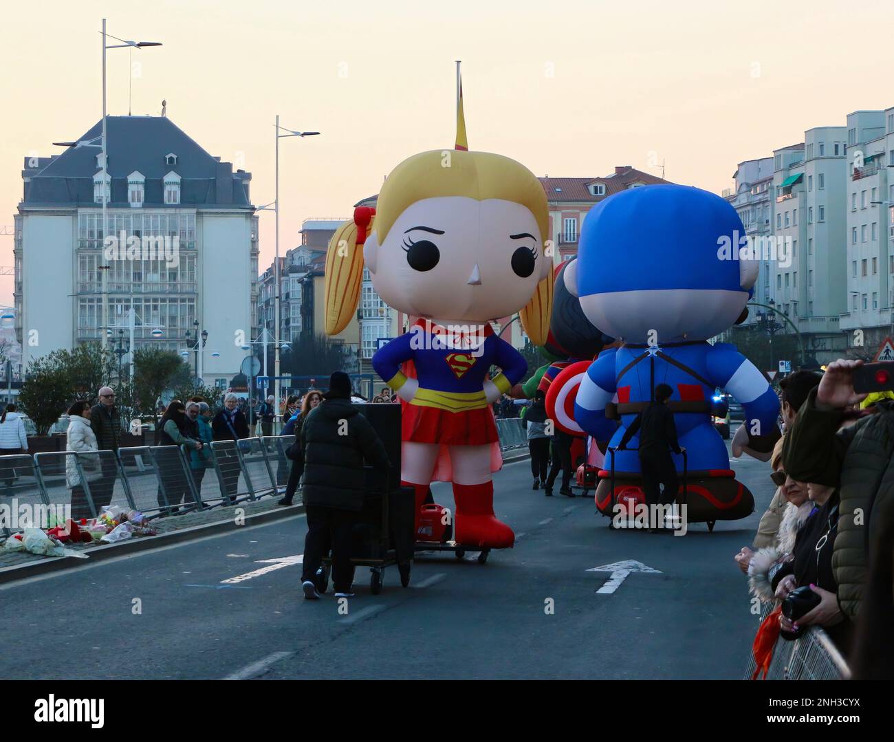 Evening carnival parade with an inflated Supergirl figure in the ...