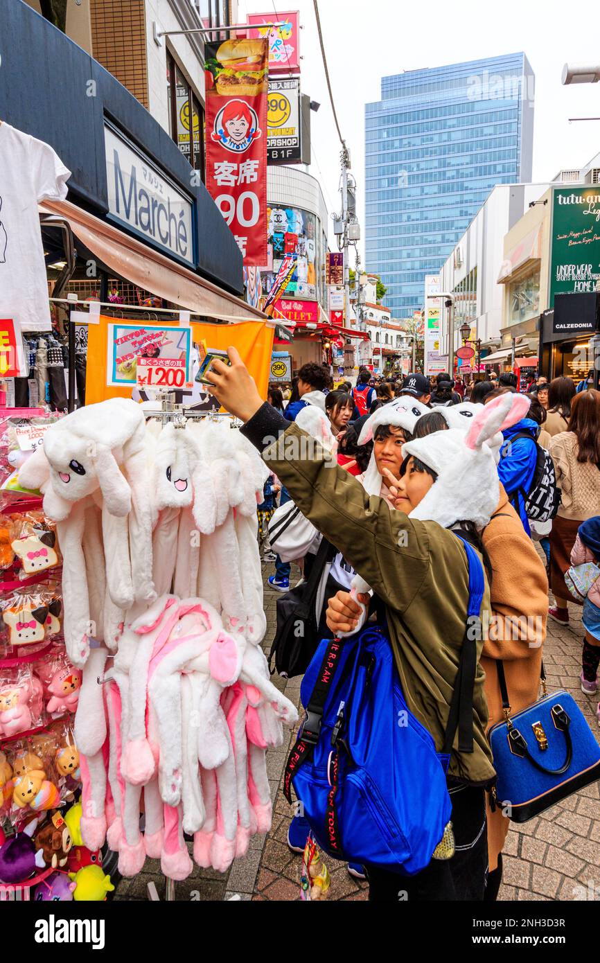 Chinese tourists take a selfie while wearing white rabbit hats by ...