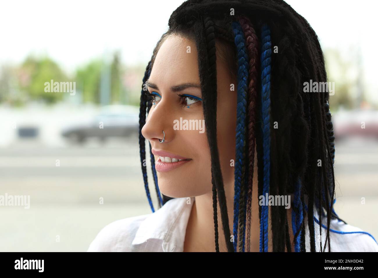 Beautiful young woman with nose piercing and dreadlocks outdoors Stock ...