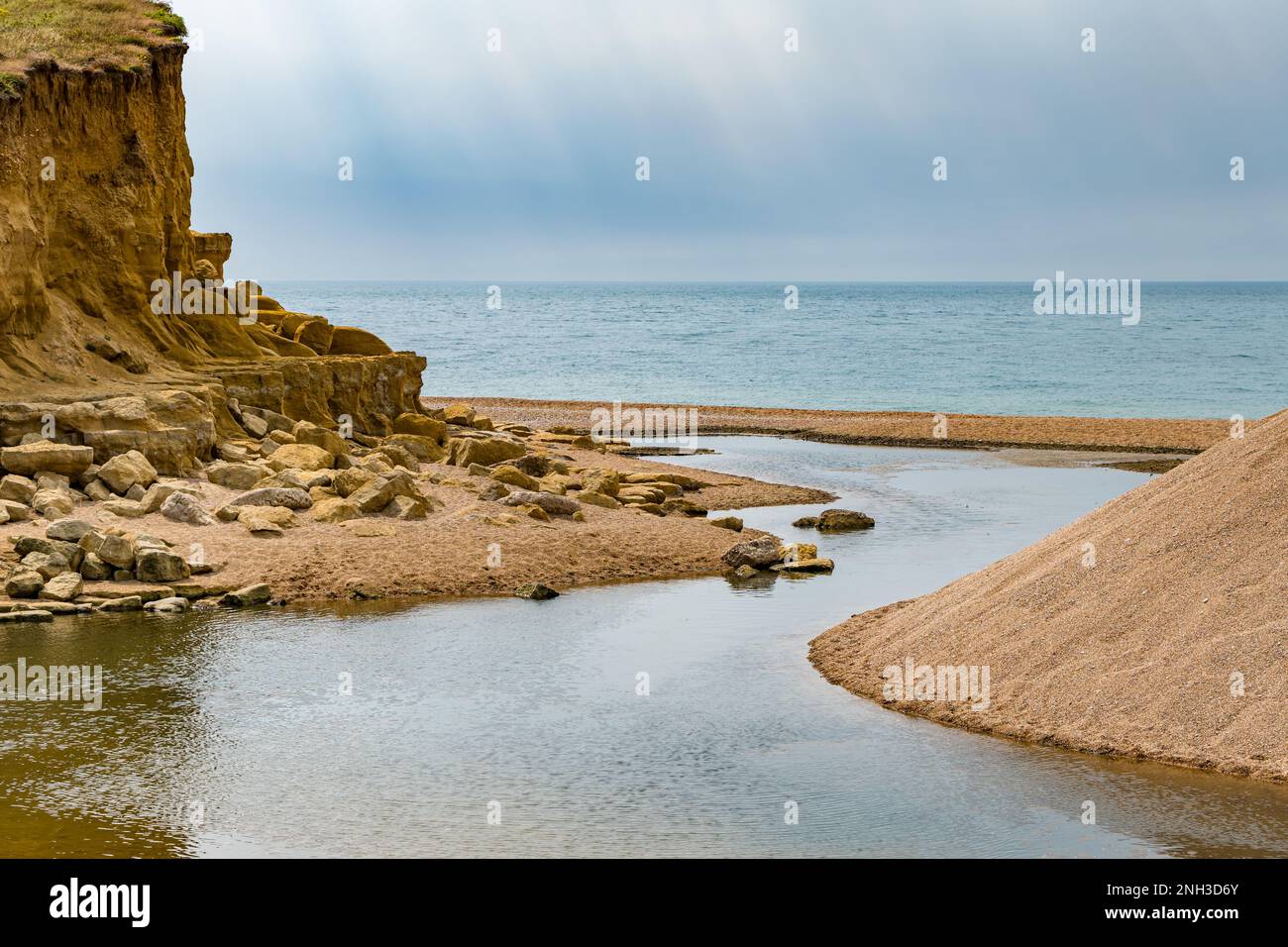 Inlet to sea at Burton Freshwater, next to crumbling limestone cliff ...