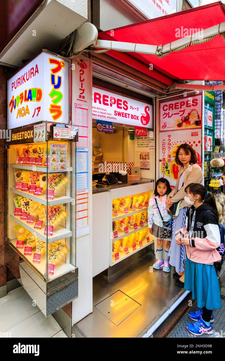 Mother and two daughters waiting at the takeaway counter of the Sweet ...