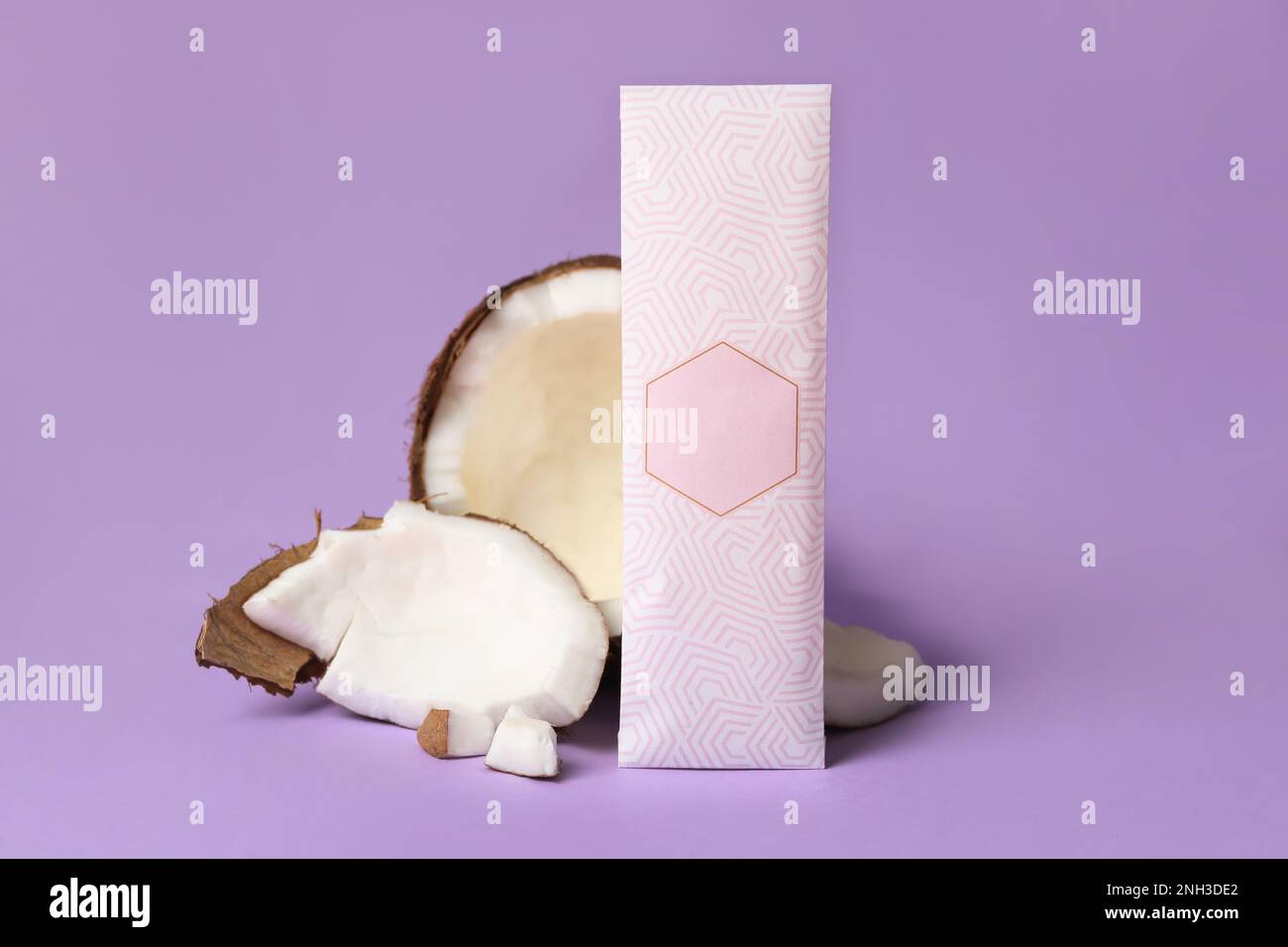 Scented sachet and pieces of coconut on violet background Stock Photo ...