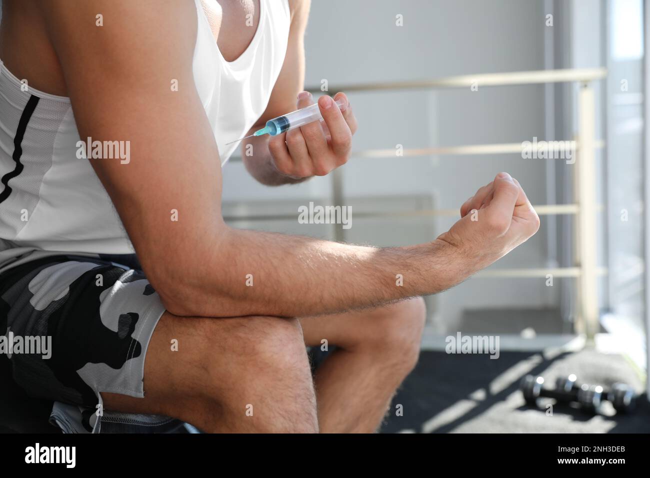 Sportsman injecting himself in gym, closeup. Doping concept Stock Photo ...
