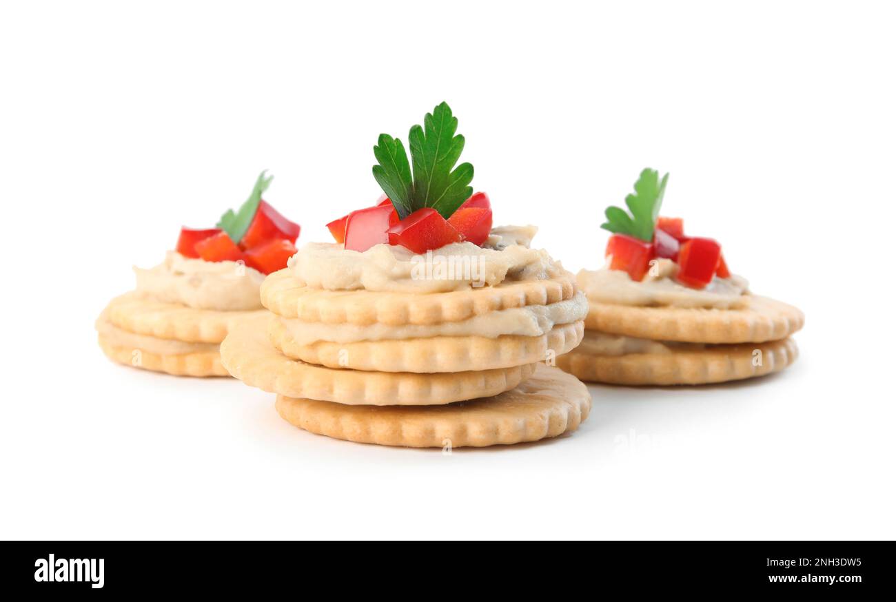 Delicious crackers with humus, bell pepper and parsley on white ...