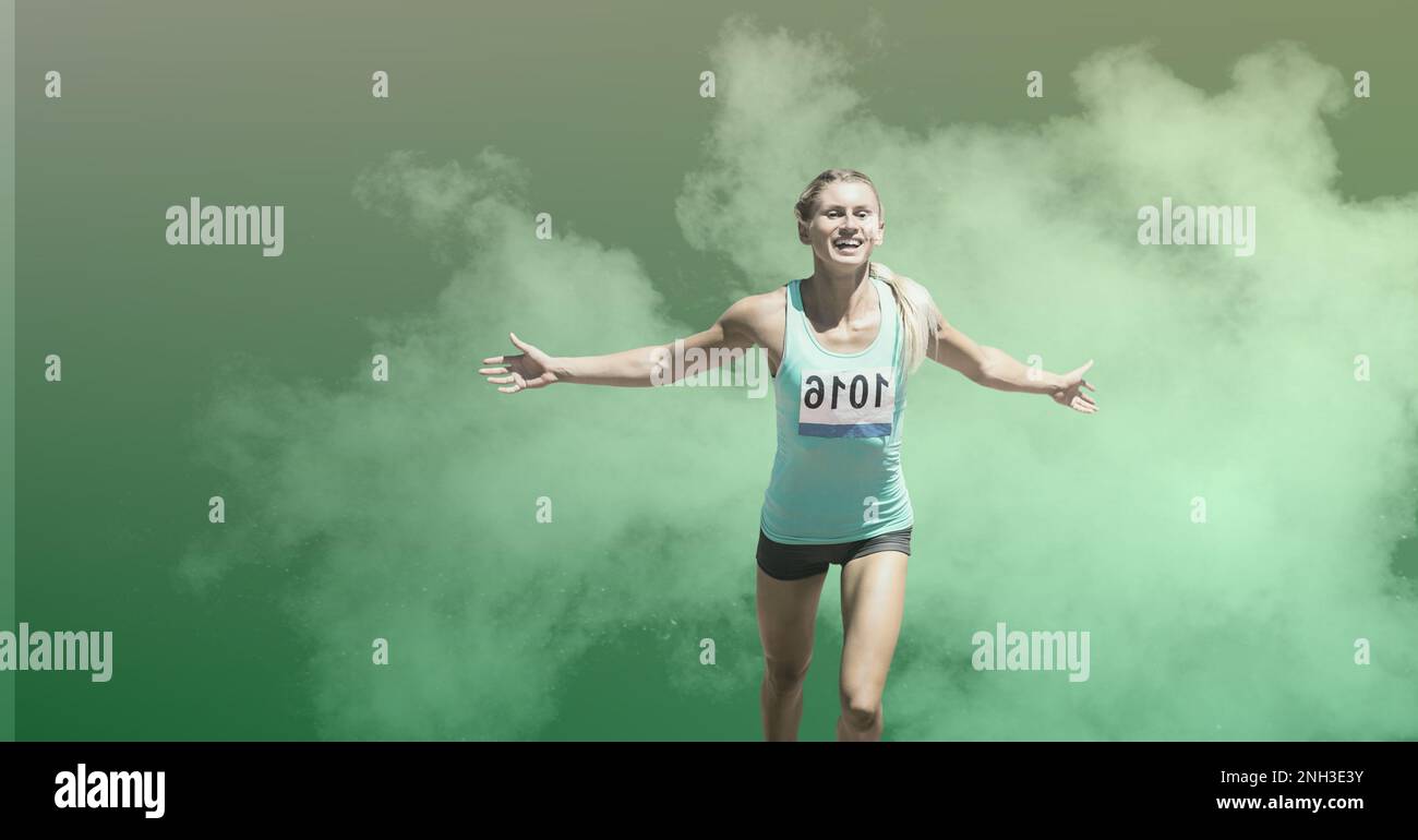 Composition of smiling female athlete running against green clouds of ...