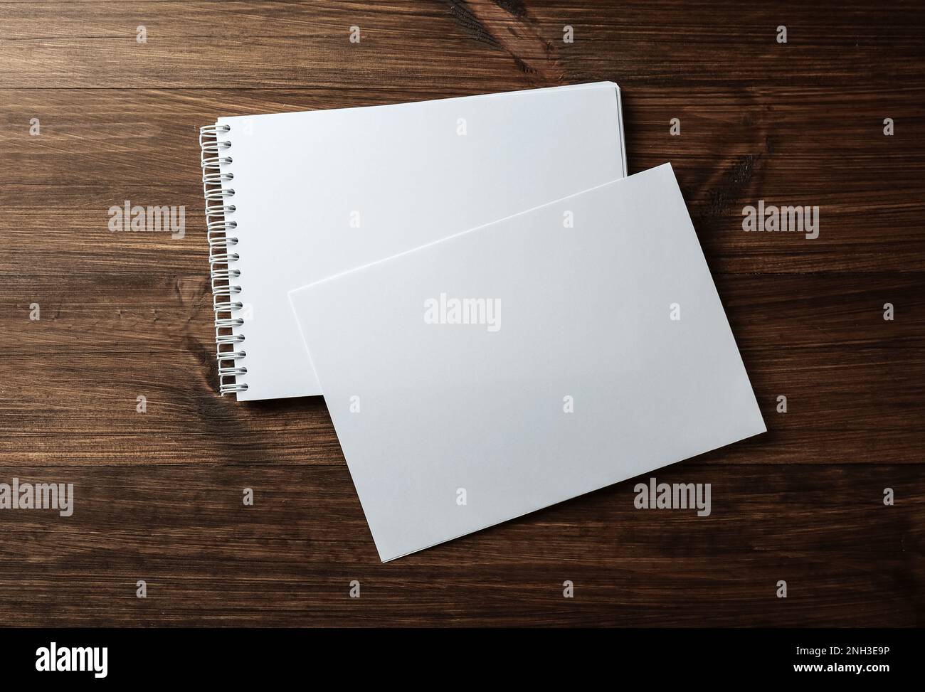 Sheet of paper and blank brochure on wooden table, flat lay. Mockup for ...