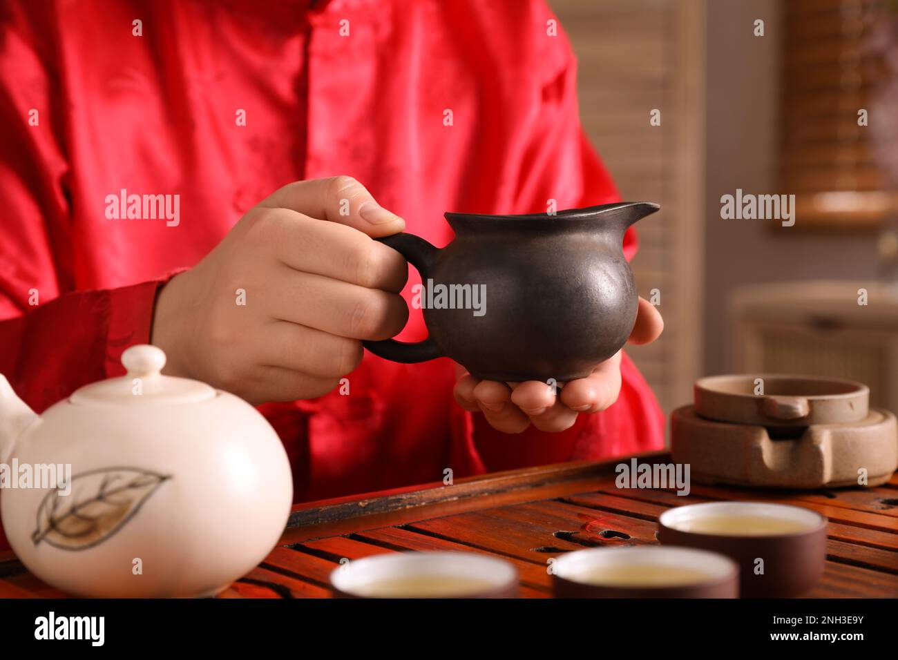 Master conducting traditional tea ceremony at table, closeup Stock ...