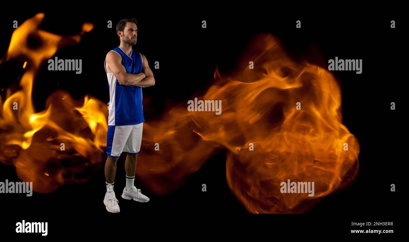 Composition of male basketball player standing with arms crossed over ...