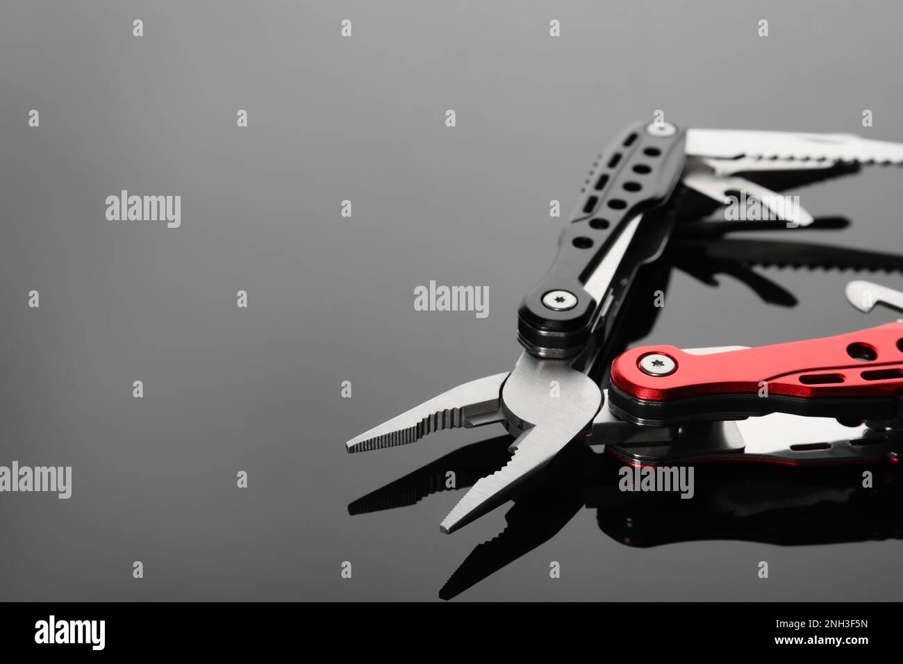 Compact portable multitool on grey table, closeup. Space for text Stock ...