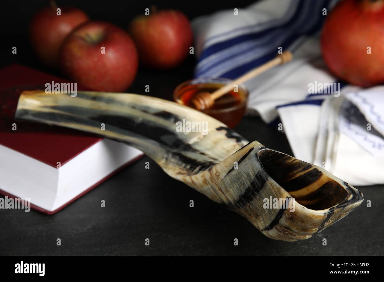 Shofar and Torah on black table, closeup. Rosh Hashanah celebration ...