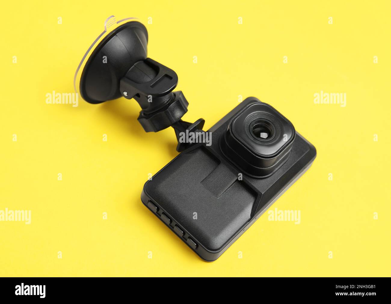 Modern car dashboard camera with suction mount on yellow background ...
