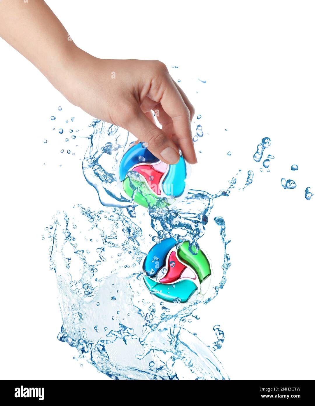 Splashes of water and woman holding laundry capsule on white background ...