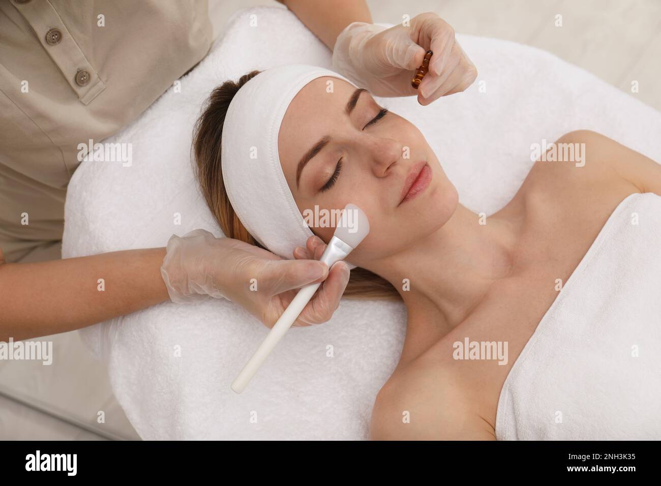 Young woman during face peeling procedure in salon Stock Photo - Alamy