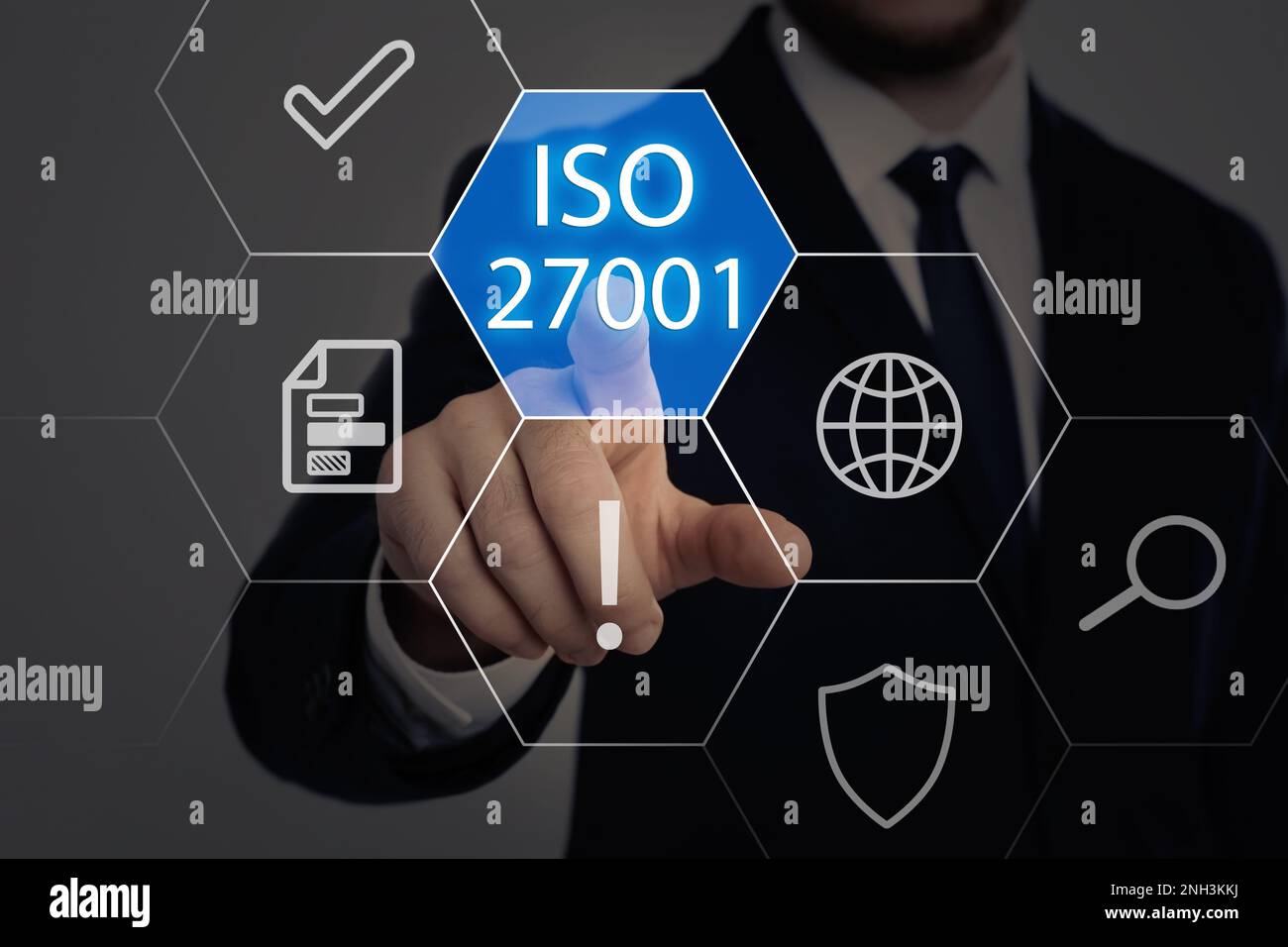Businessman pointing at virtual icon with text ISO 27001 on dark ...