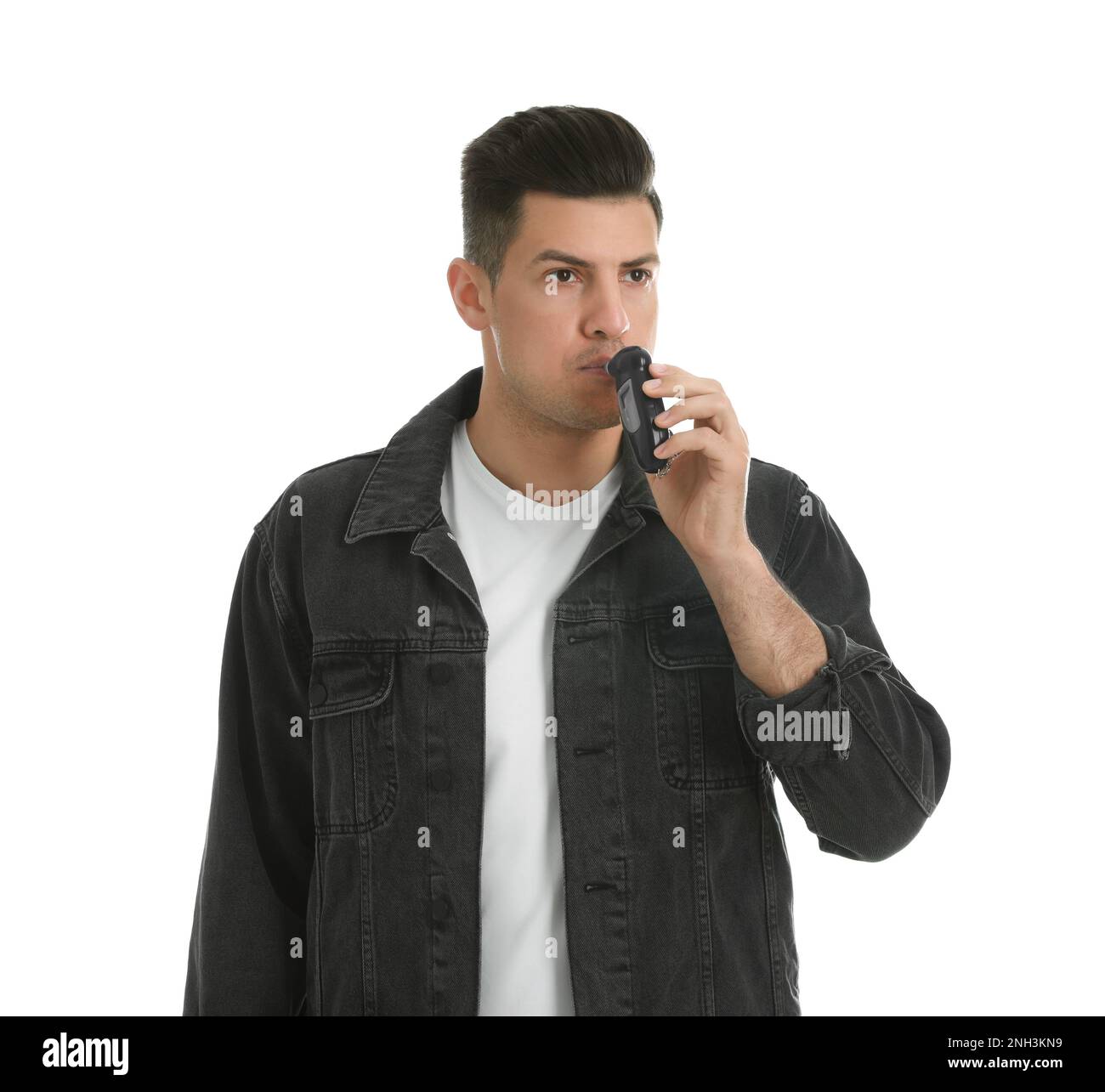 Man blowing into breathalyzer on white background Stock Photo - Alamy
