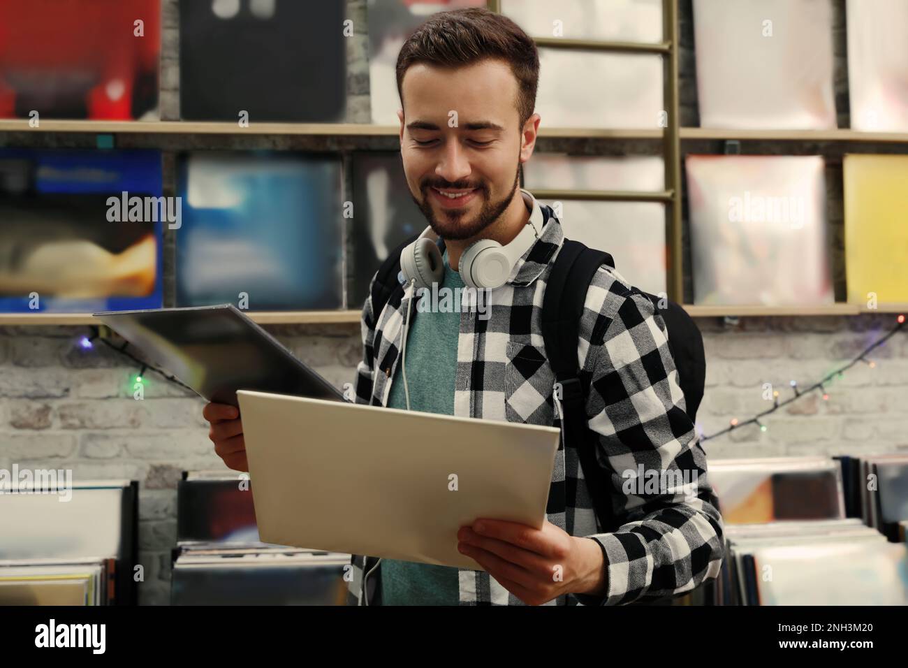 Young man with vinyl records in store Stock Photo - Alamy