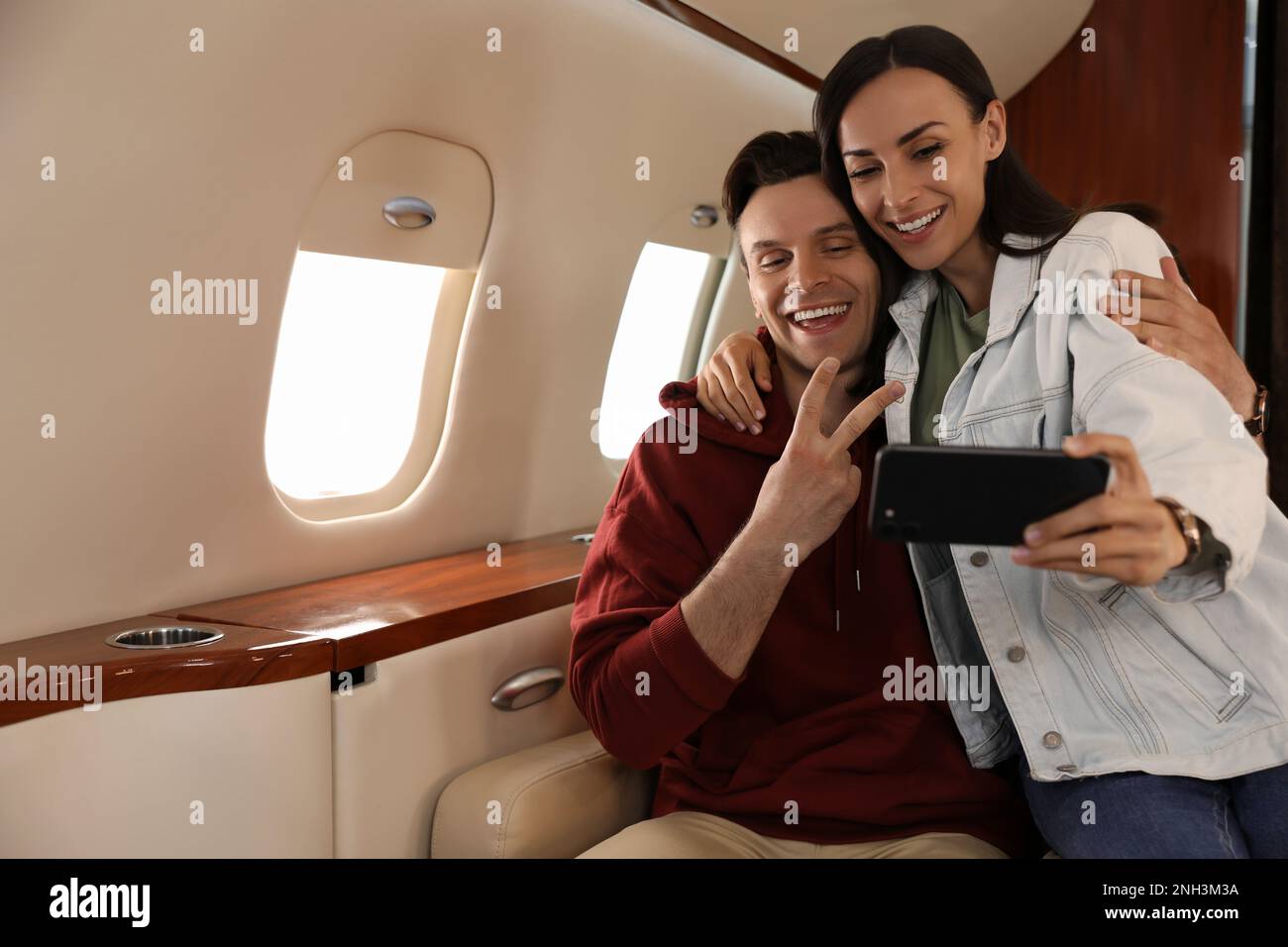 Lovely young couple taking selfie in airplane during flight Stock Photo ...