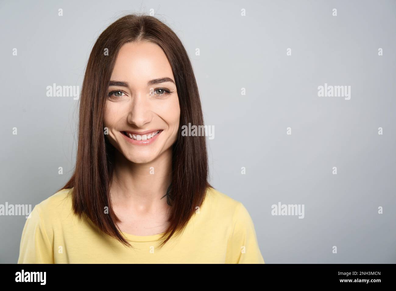 Portrait of pretty young woman with gorgeous chestnut hair and charming ...