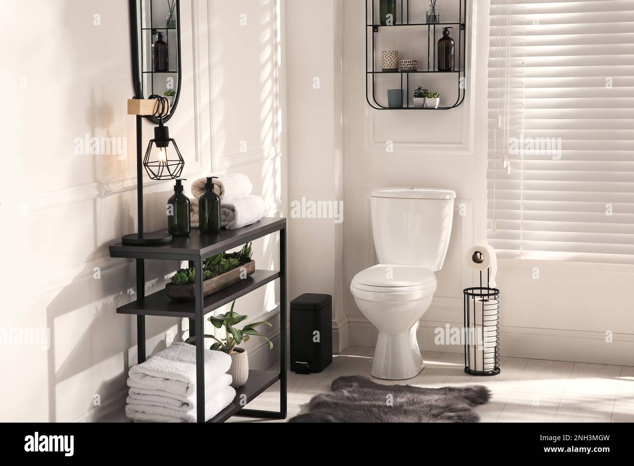 Modern toilet bowl in comfortable restroom. Interior design Stock Photo ...