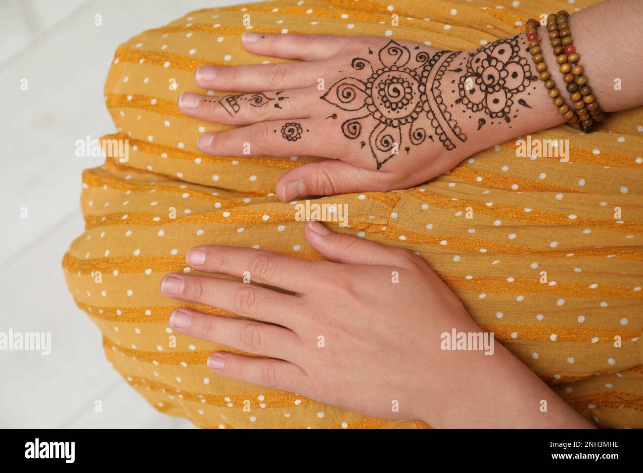 Woman with beautiful henna tattoo on hand, top view. Traditional mehndi ...