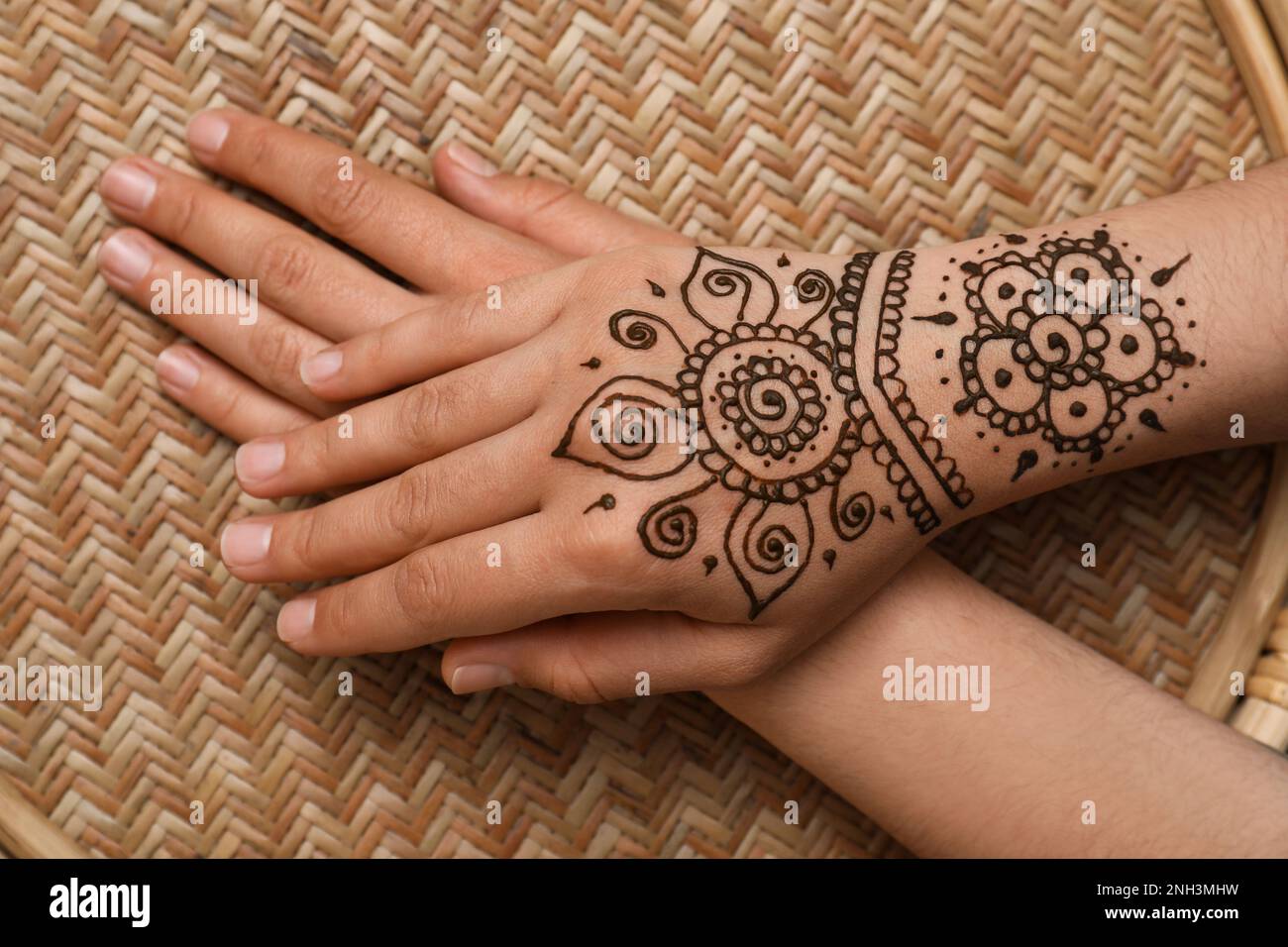 Woman with beautiful henna tattoo on hand, top view. Traditional mehndi ...