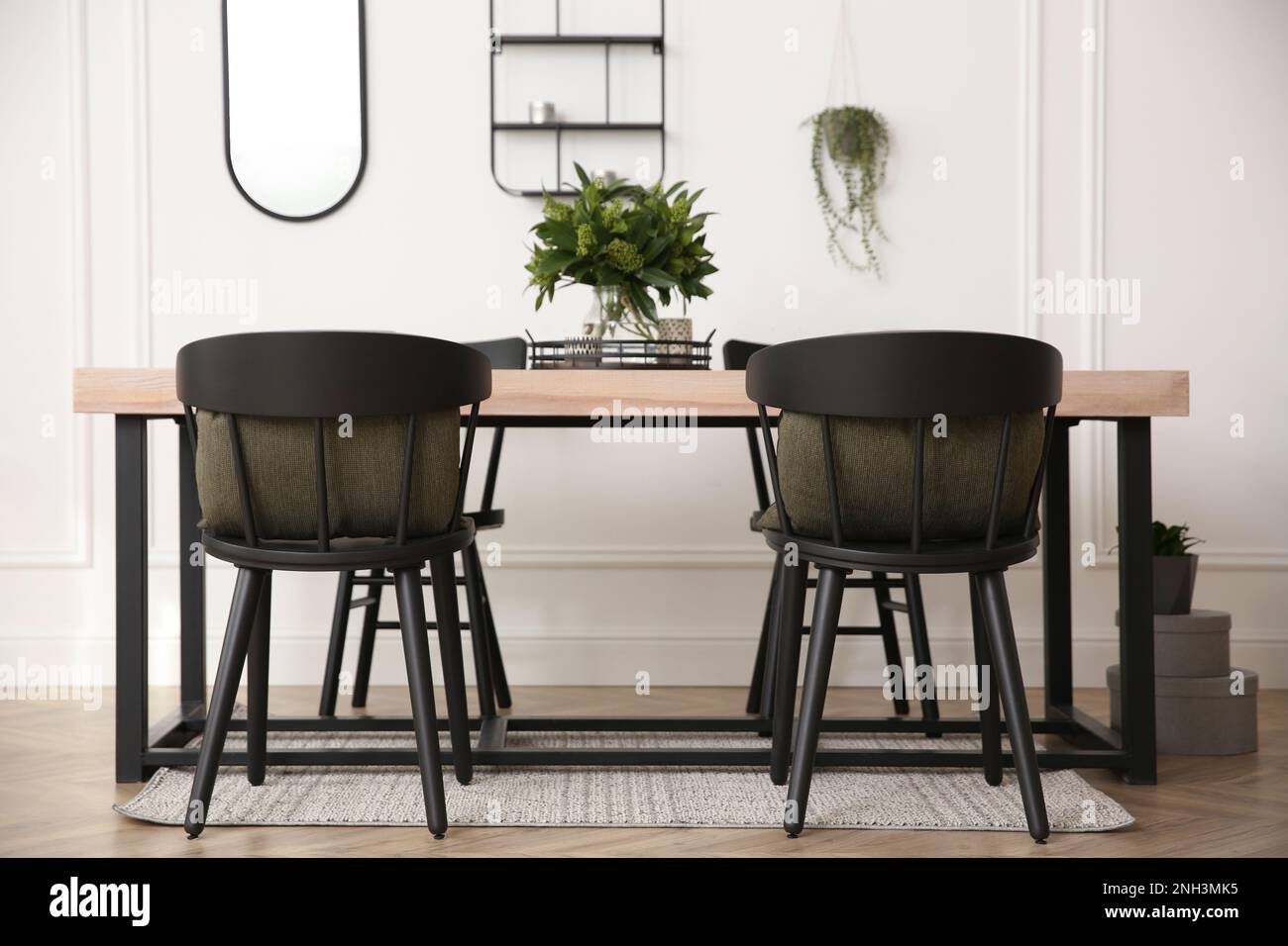 Stylish wooden dining table and chairs in room. Interior design Stock ...