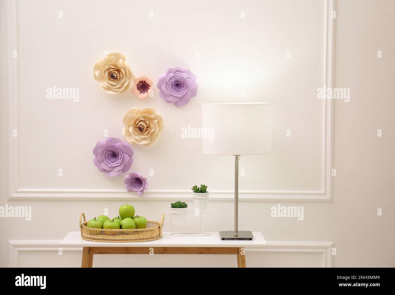 Console table near wall with floral decor in room. Interior design ...