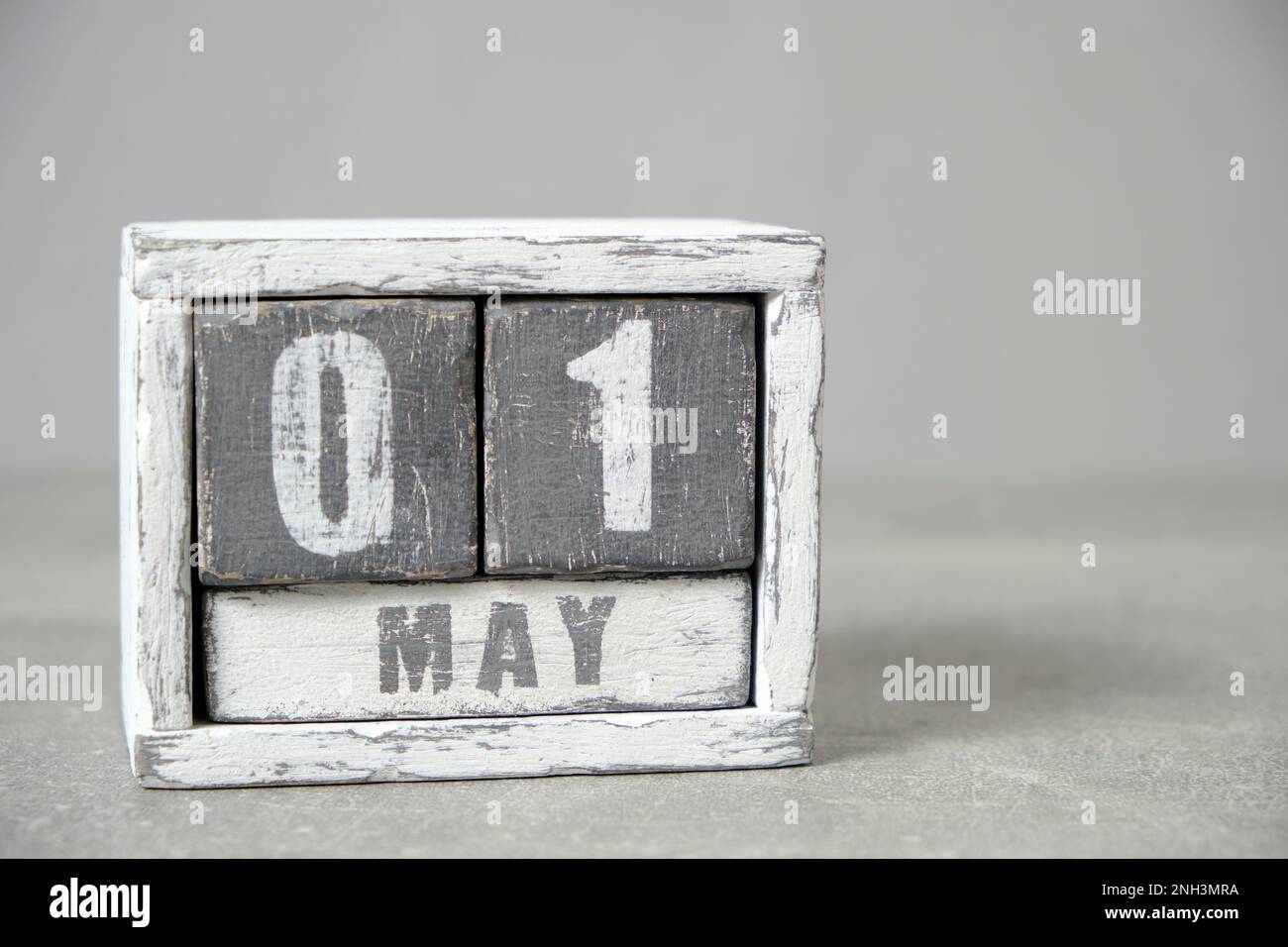 May 1, Wooden desktop calendar gray background.Spring month depicted on ...