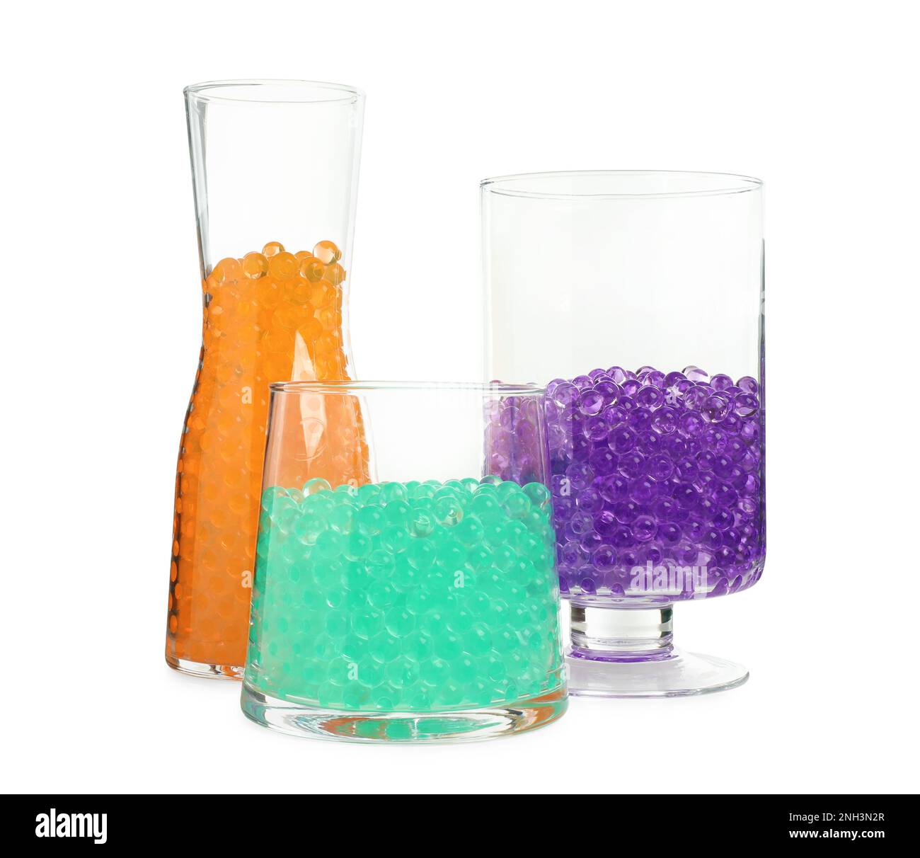 Different color fillers in glass vases isolated on white. Water beads ...